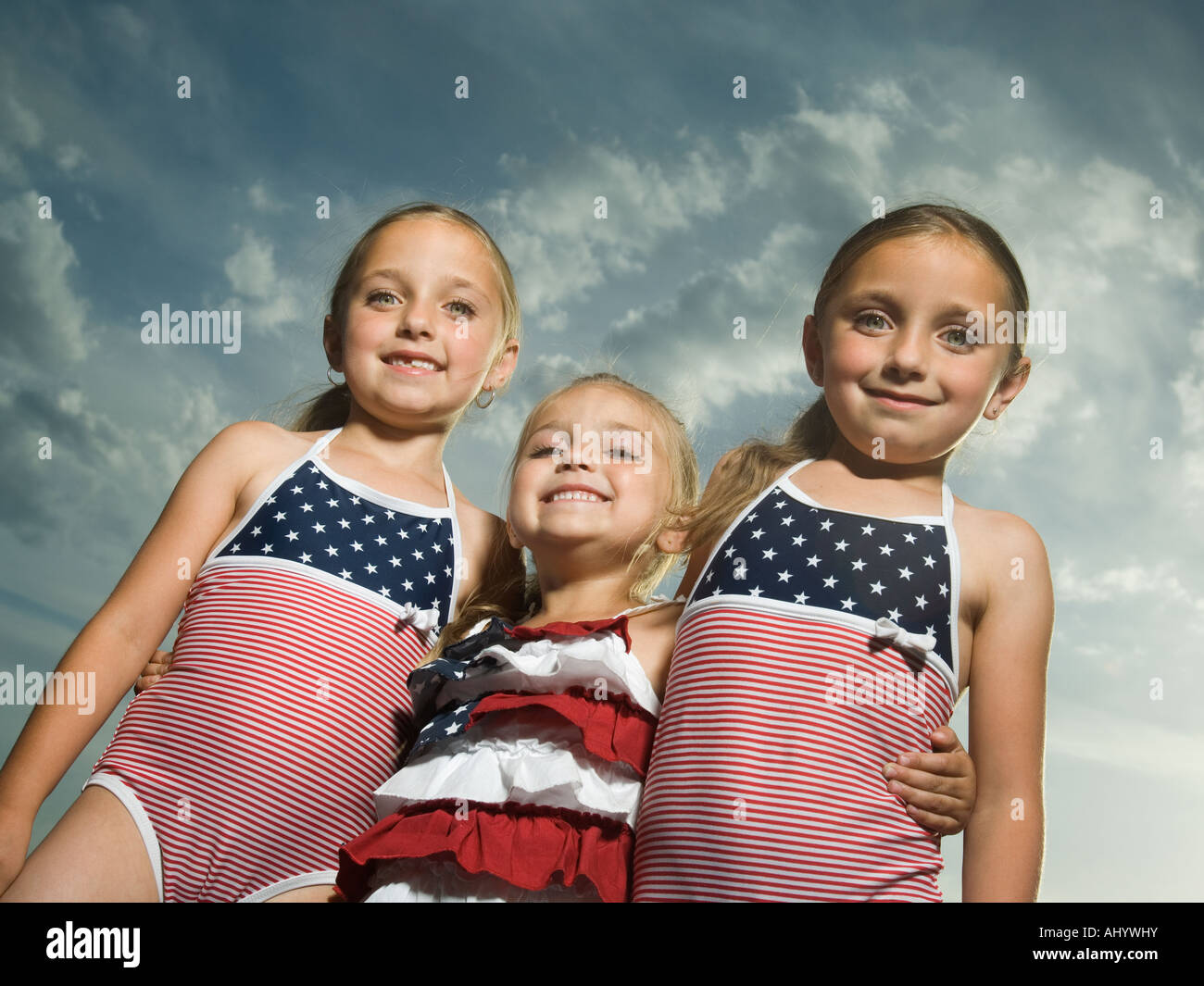 Three young sisters hugging Stock Photo - Alamy