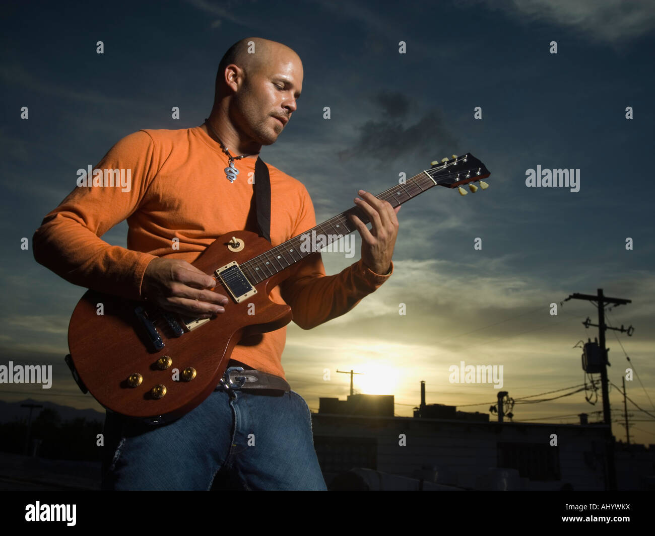 Side profile man playing guitar hi-res stock photography and images - Alamy
