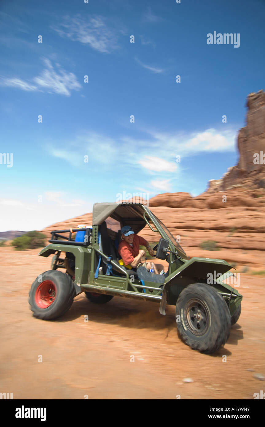 Man driving off-road vehicle in desert Stock Photo - Alamy