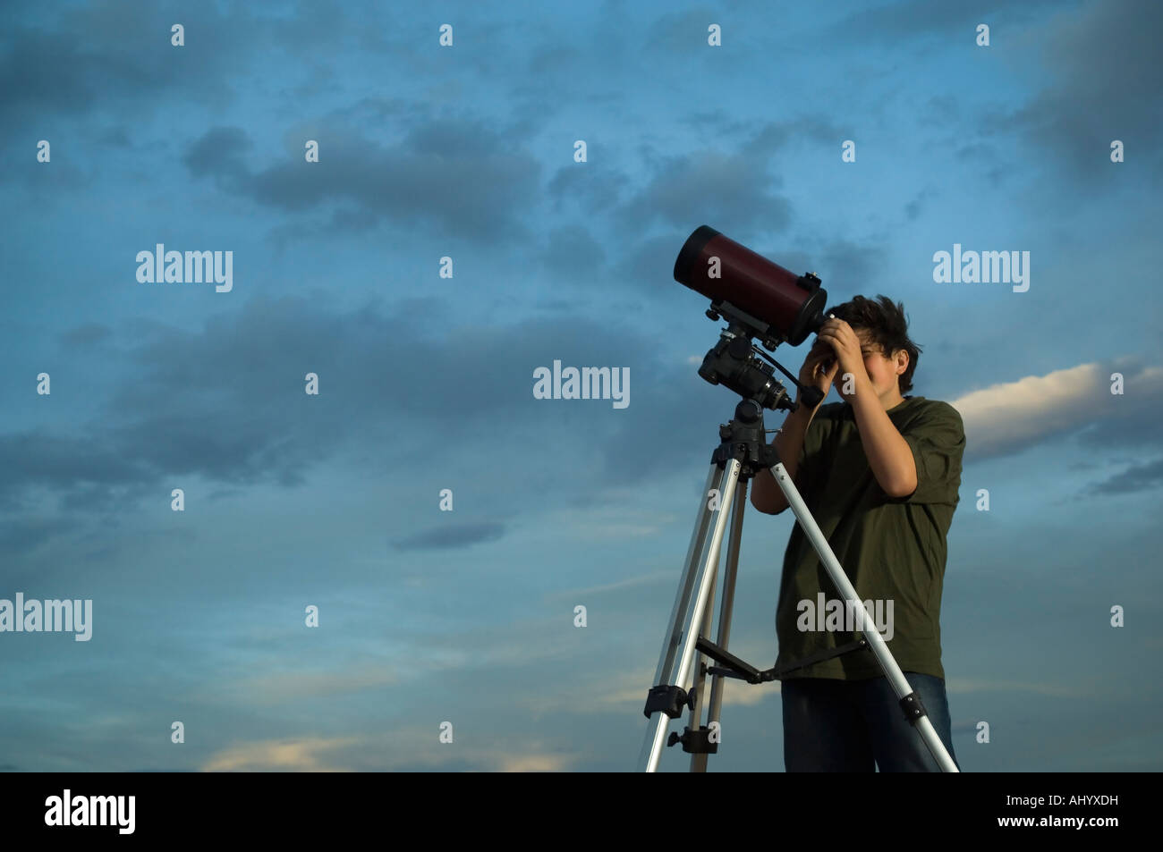 Man using telescope on tripod Stock Photo - Alamy