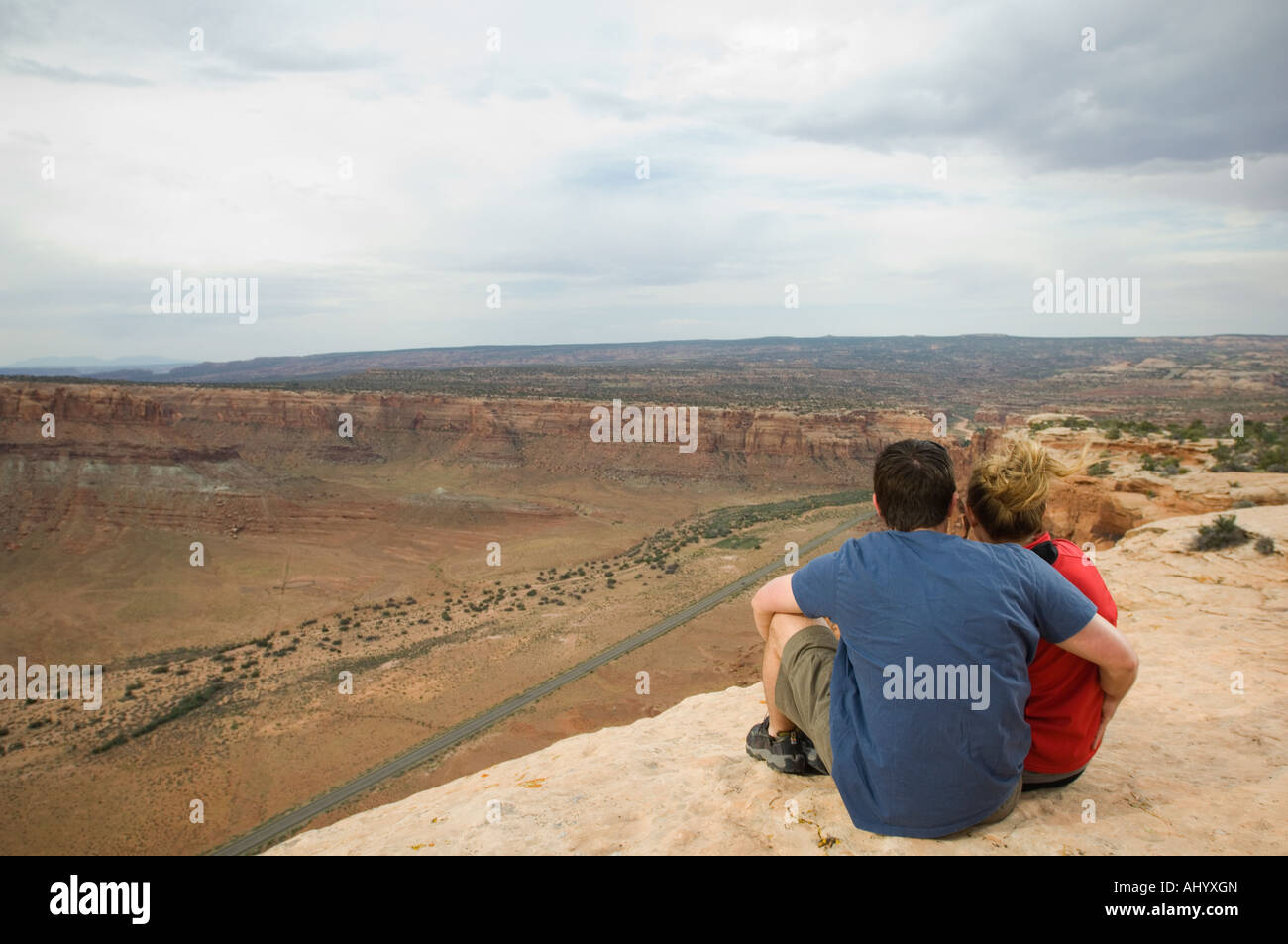 Couple looking over edge of cliff Stock Photo - Alamy