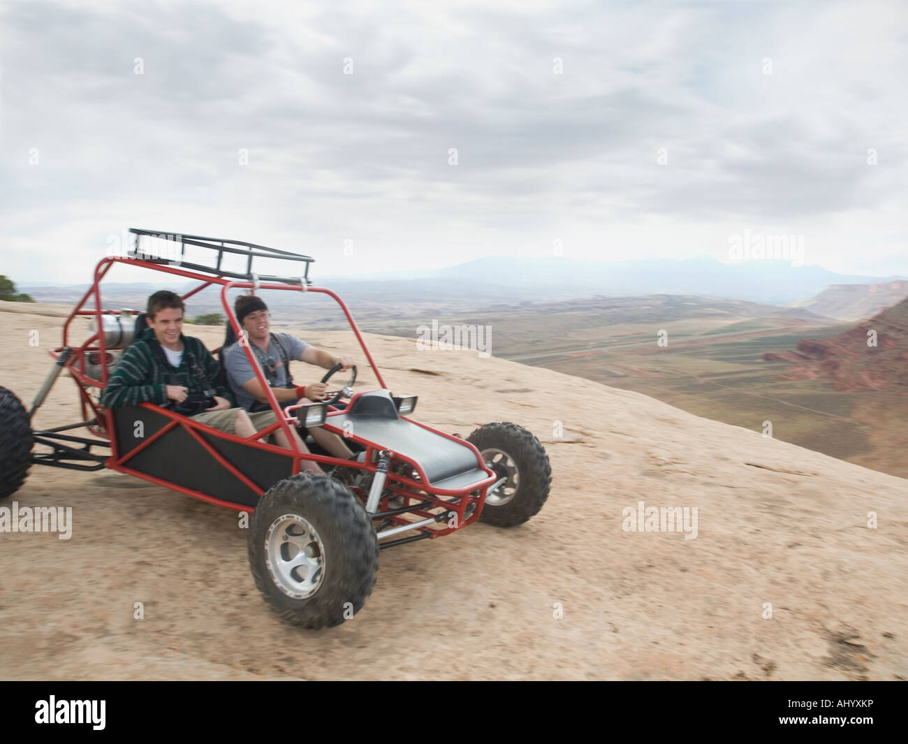 People in off-road vehicle on rock formation Stock Photo - Alamy