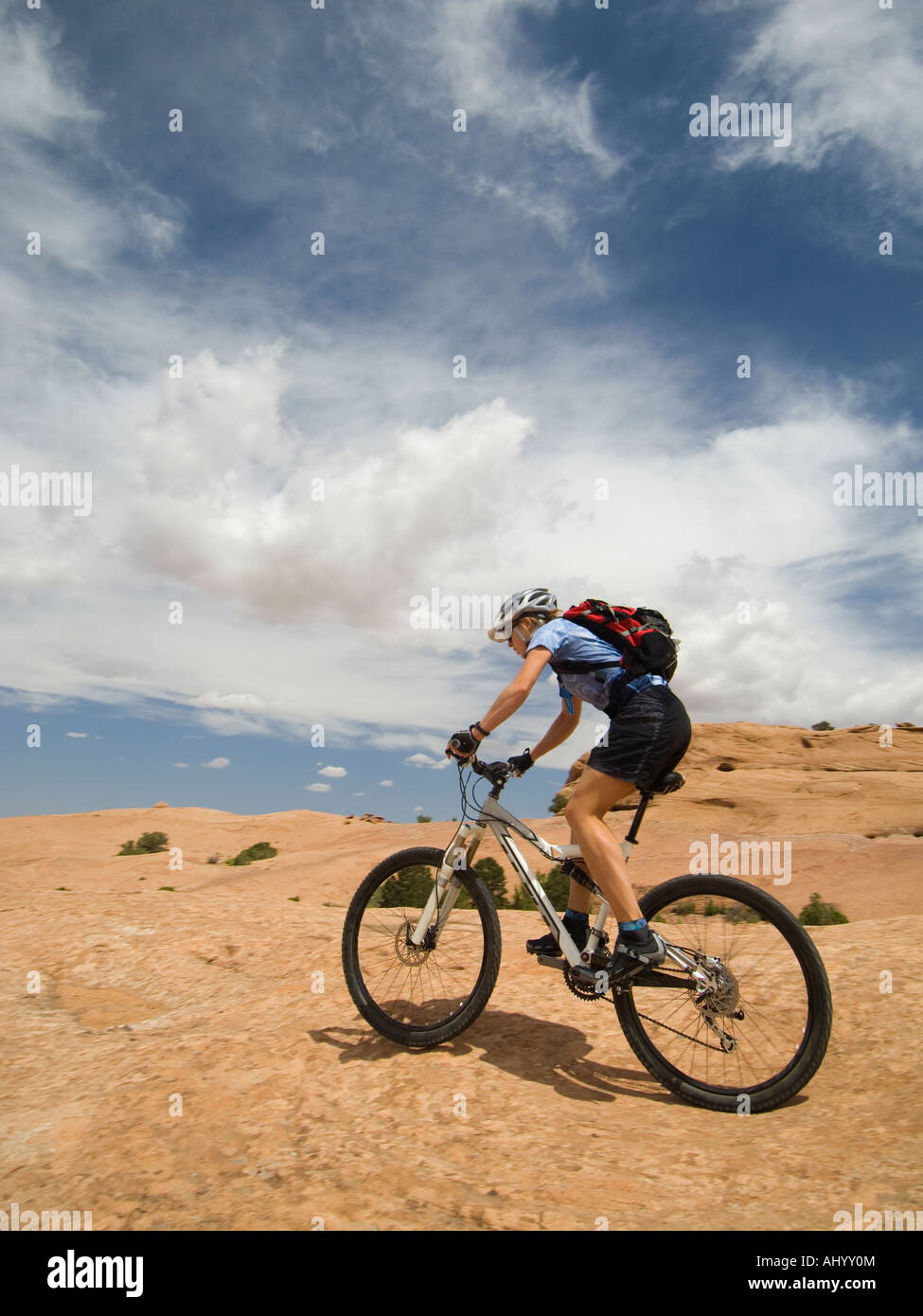 Woman riding mountain bike in desert Stock Photo - Alamy