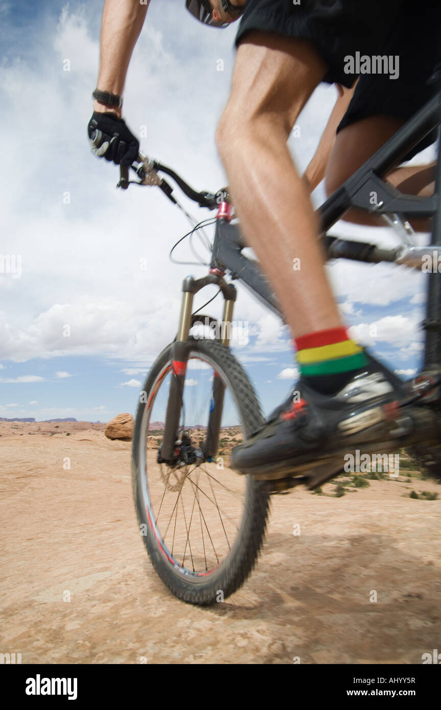 Low angle view of man riding mountain bike Stock Photo - Alamy