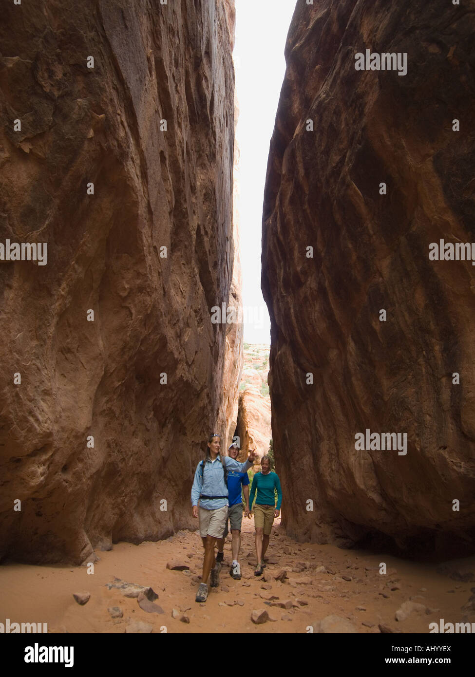 People hiking between rock formations Stock Photo - Alamy