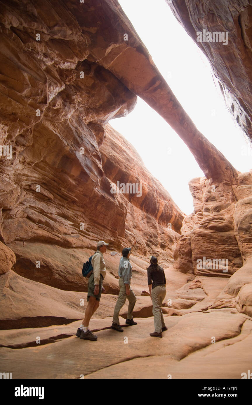 People looking up at rock formations Stock Photo - Alamy