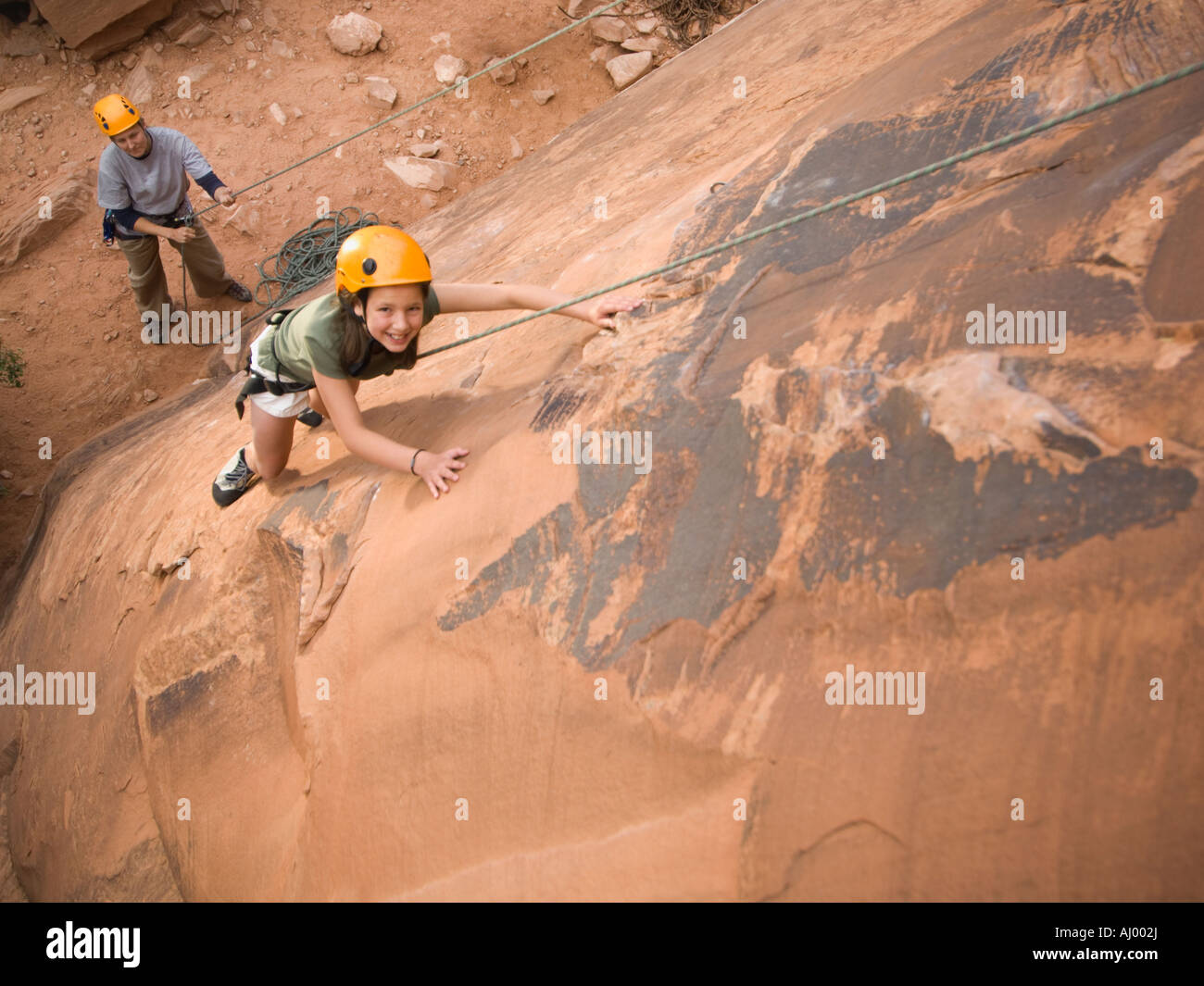 Couple scaling cliff hi-res stock photography and images - Alamy
