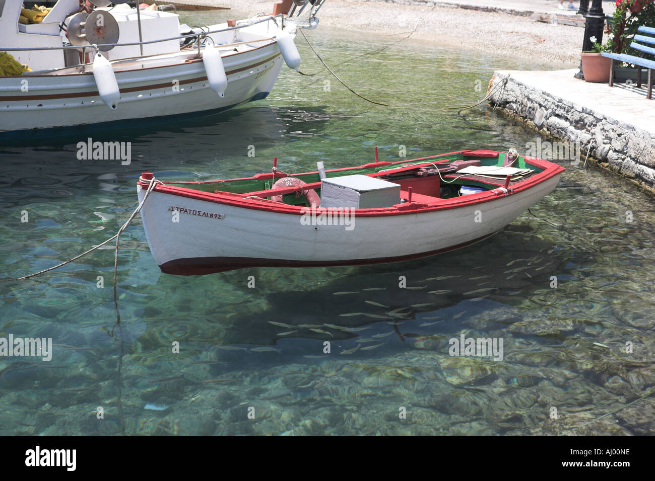 Small boat with fish swimming underneath, Vathi, Ithaca, Ionian Islands ...