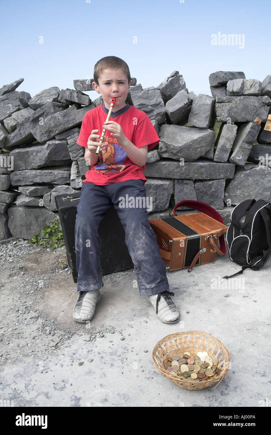 Young boy busking and playing a tin whistle Inishmore, Aran islands ...