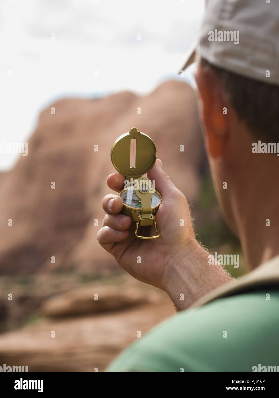 Man looking at compass Stock Photo - Alamy