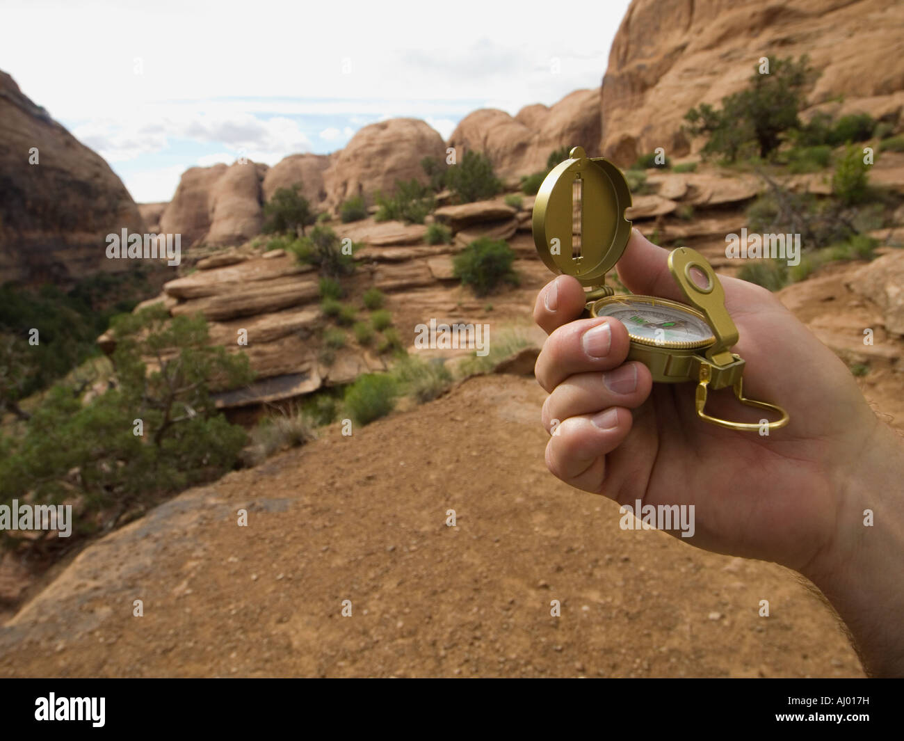 Man holding compass Stock Photo - Alamy