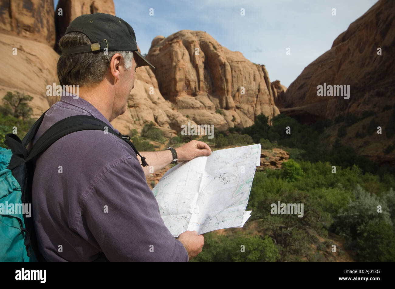 Man looking at map Stock Photo - Alamy