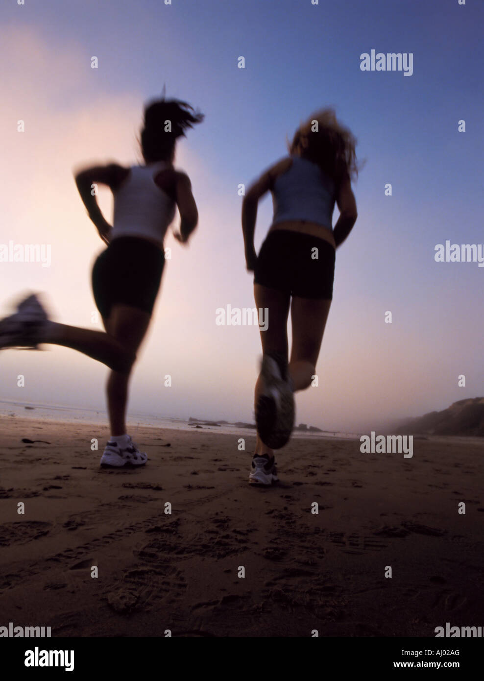 Women jogging on beach Stock Photo - Alamy