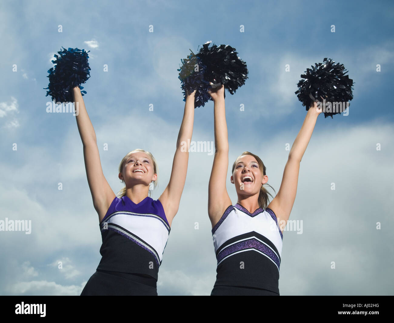 Cheerleaders with pom poms hi-res stock photography and images - Alamy