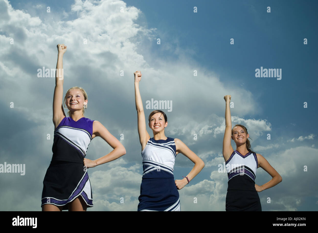 Cheerleaders with arms raised Stock Photo - Alamy