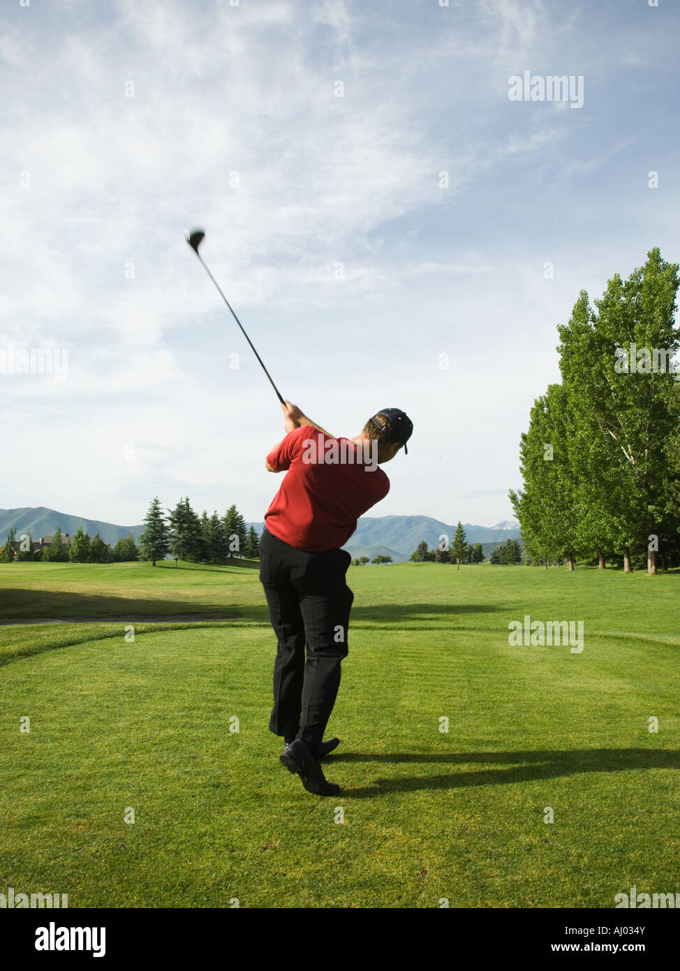 Man swinging golf club Stock Photo - Alamy