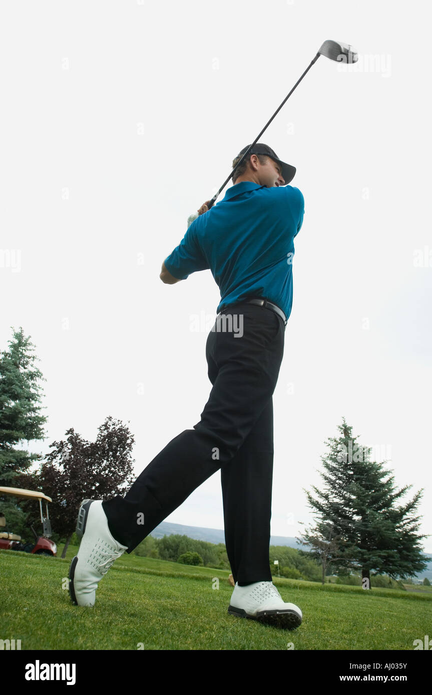 Man swinging golf club Stock Photo - Alamy