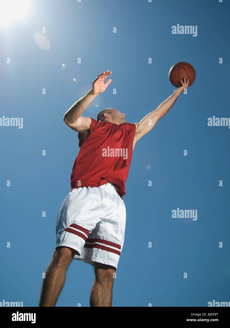 Man jumping with basketball Stock Photo - Alamy