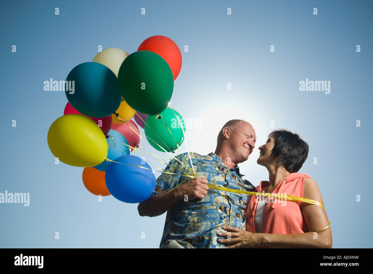 Couple holding balloons Stock Photo - Alamy