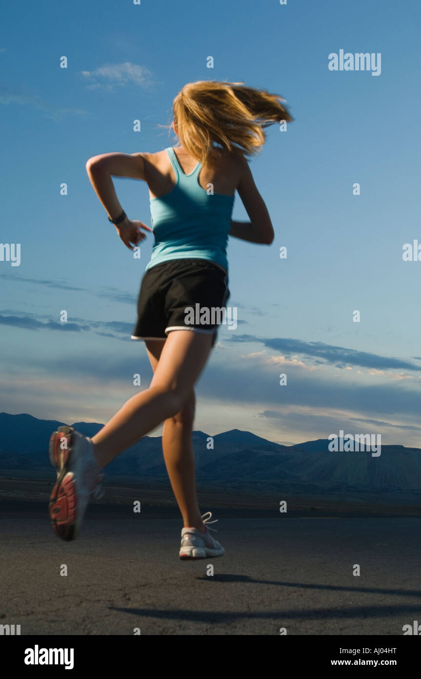 Woman in athletic gear running Stock Photo - Alamy