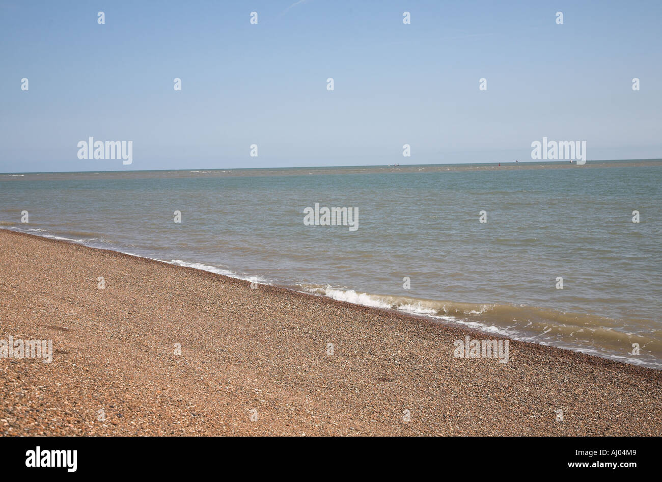North Sea gentle waves and shingle beach at Shingle Street Suffolk ...