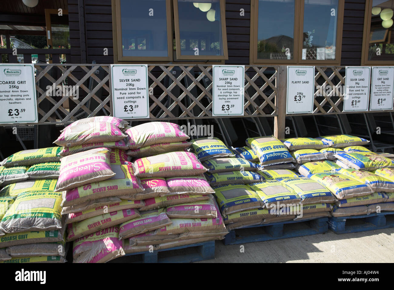 Bags of different types of sand on display in a garden centre Stock ...