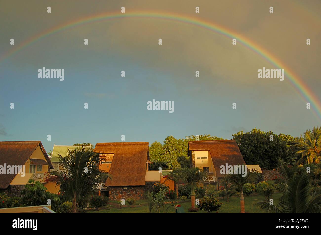 Rainbow over traditional style housing, Mauritius Stock Photo - Alamy
