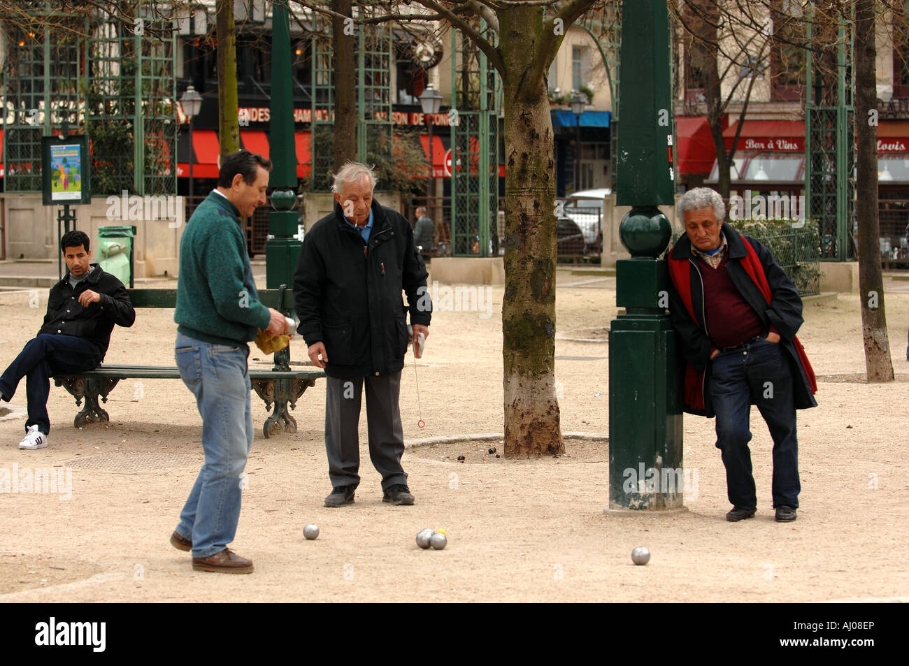 Men playing boules in a Park in Paris France. French men males leisure ...