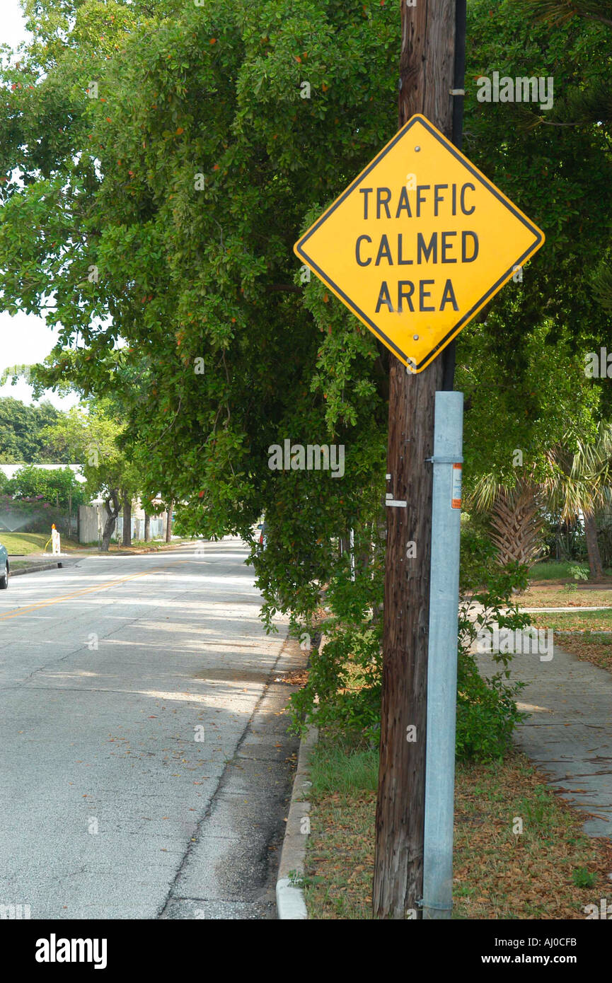 A suburban street with a yellow traffic warning sign reading Traffic ...