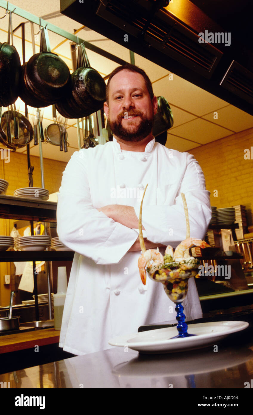 Portrait of a chef standing with his arms crossed in front of him ...