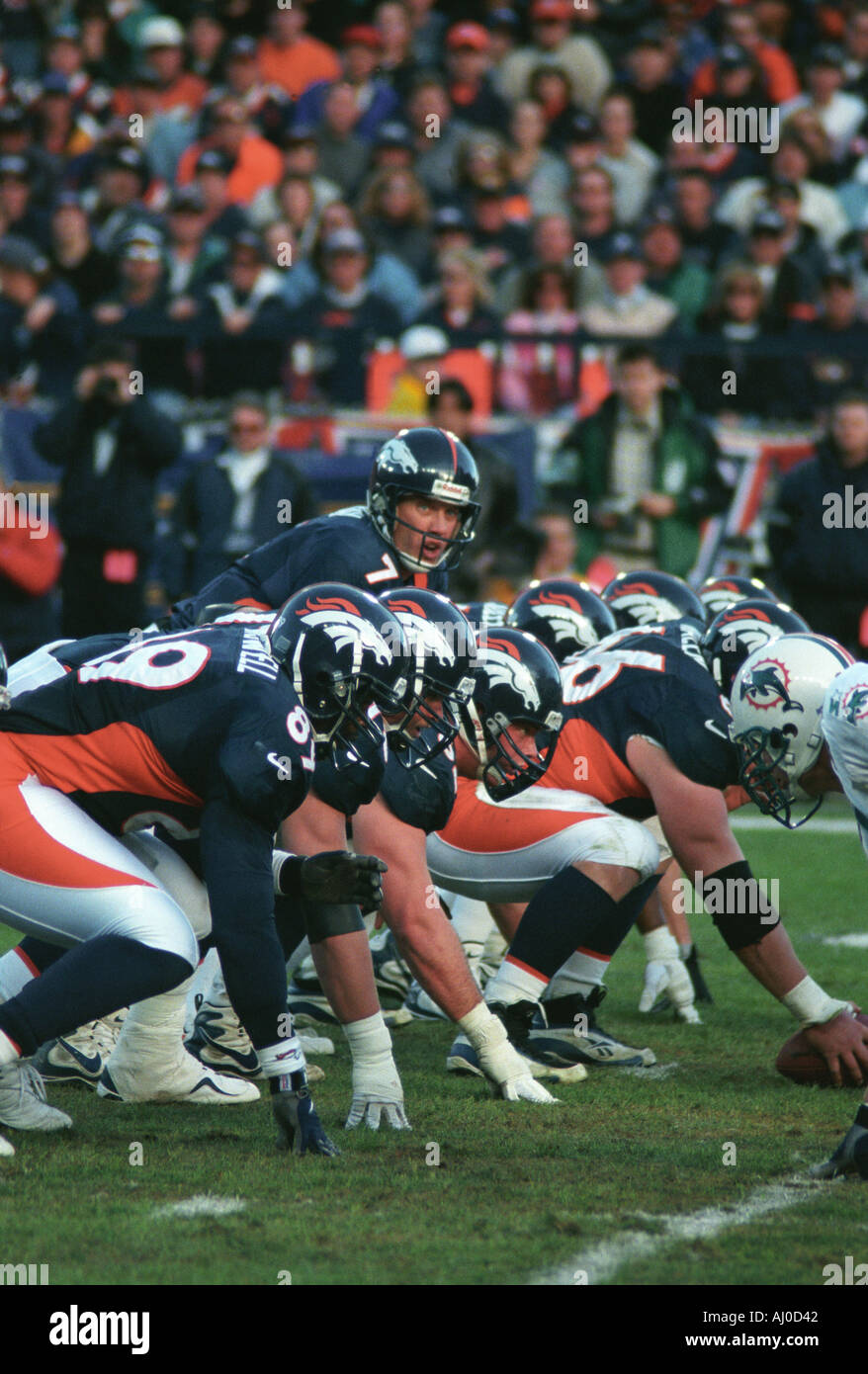 Denver Broncos line up for snap to QB John Elway during game against ...