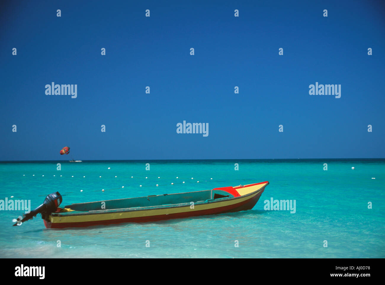 Wooden fishing boat painted in colorful rasta colors rests in the ...