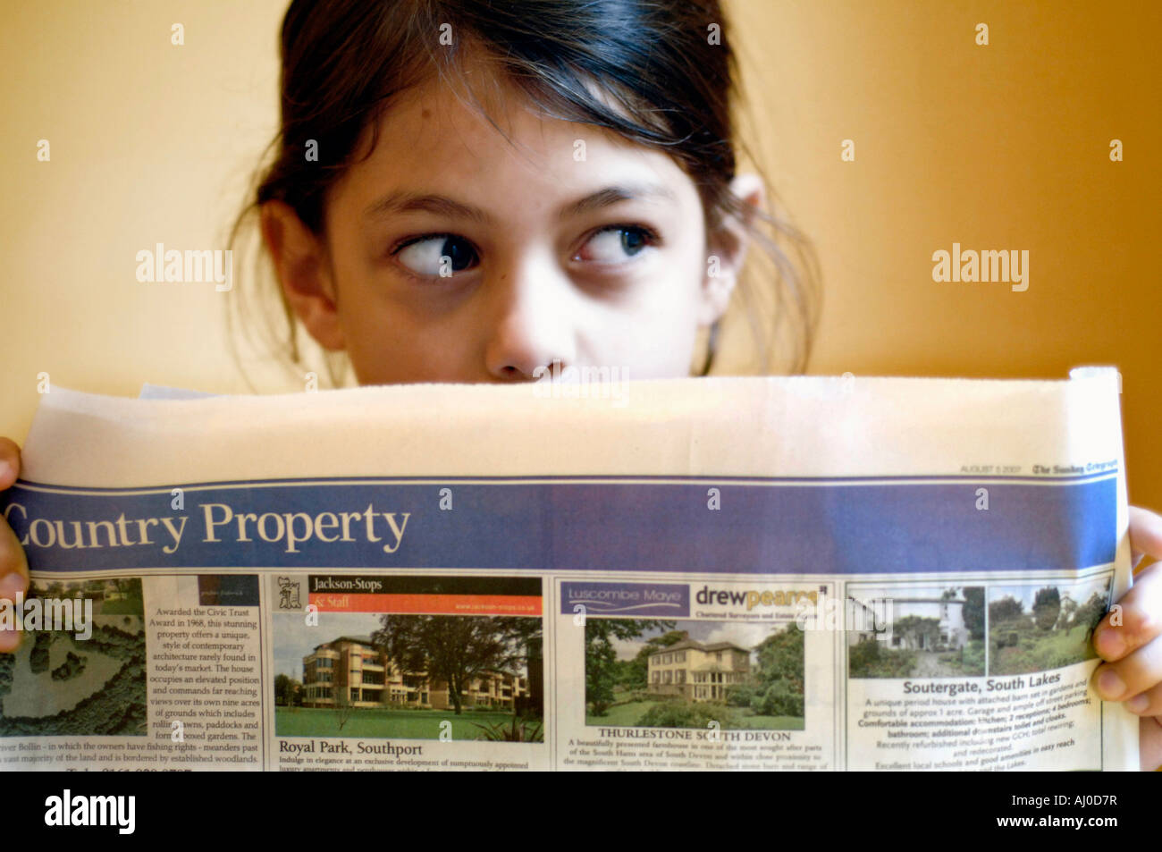 Hiding behind newspaper hi-res stock photography and images - Alamy