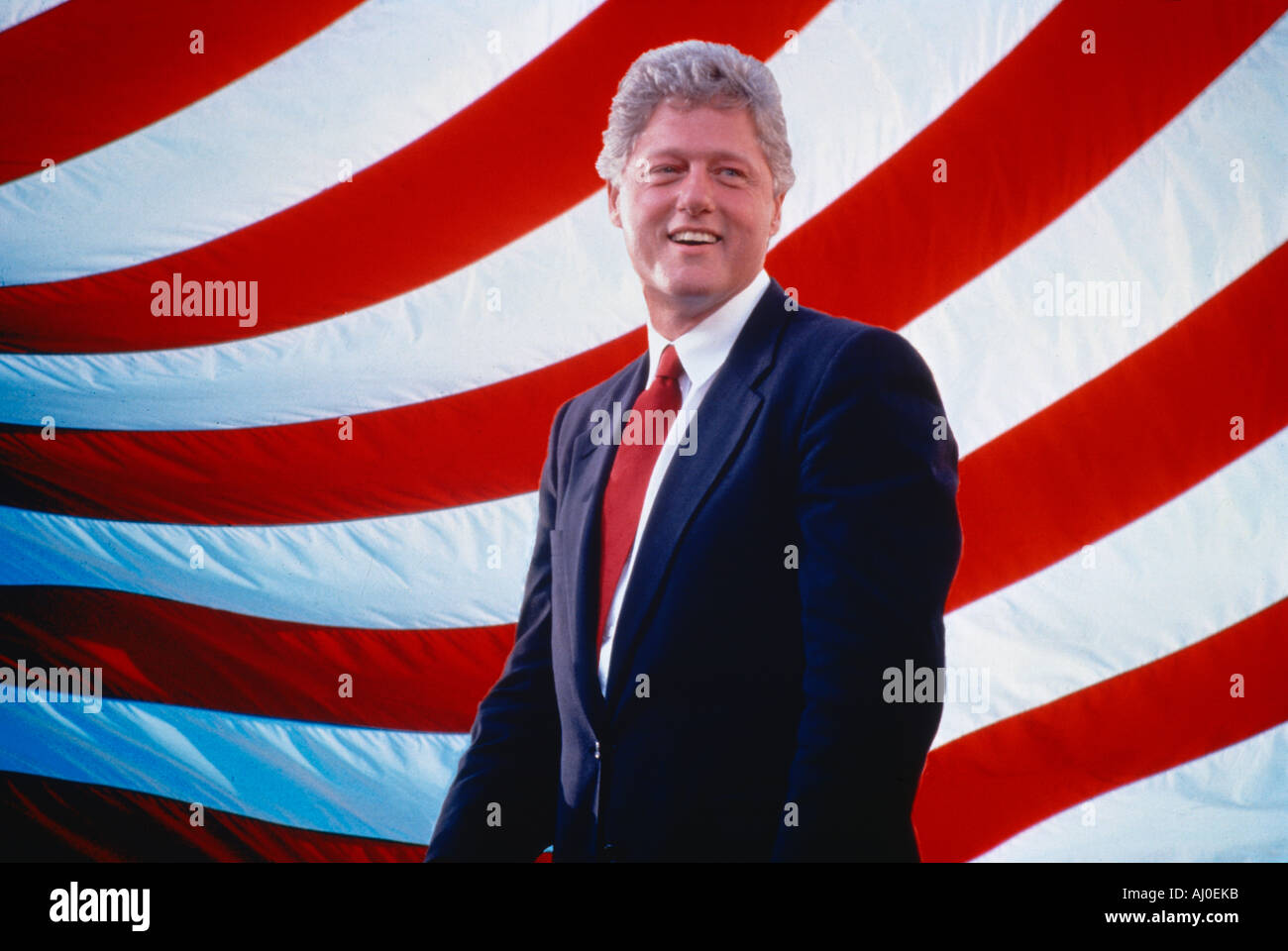President William Jefferson Clinton in front of American flag stripes ...