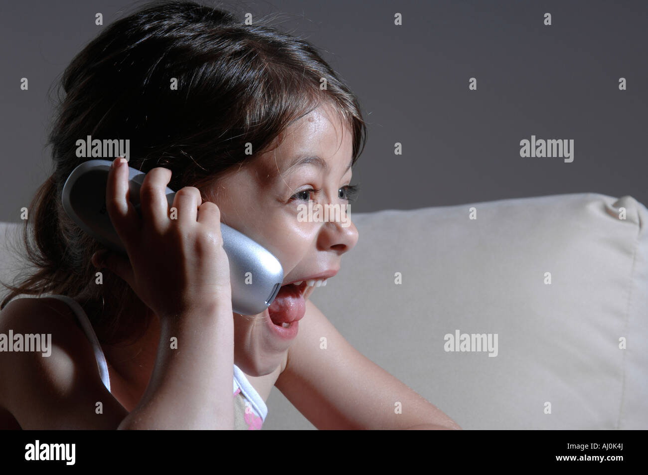 a happy young child talking on phone Stock Photo - Alamy