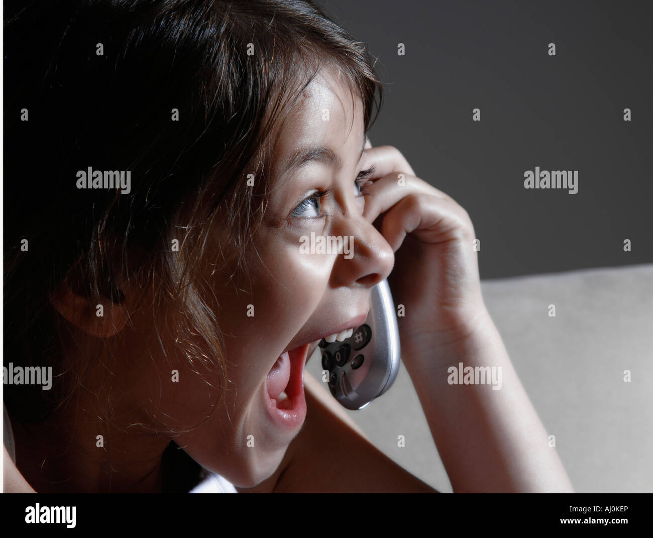 a happy young child talking on phone Stock Photo - Alamy