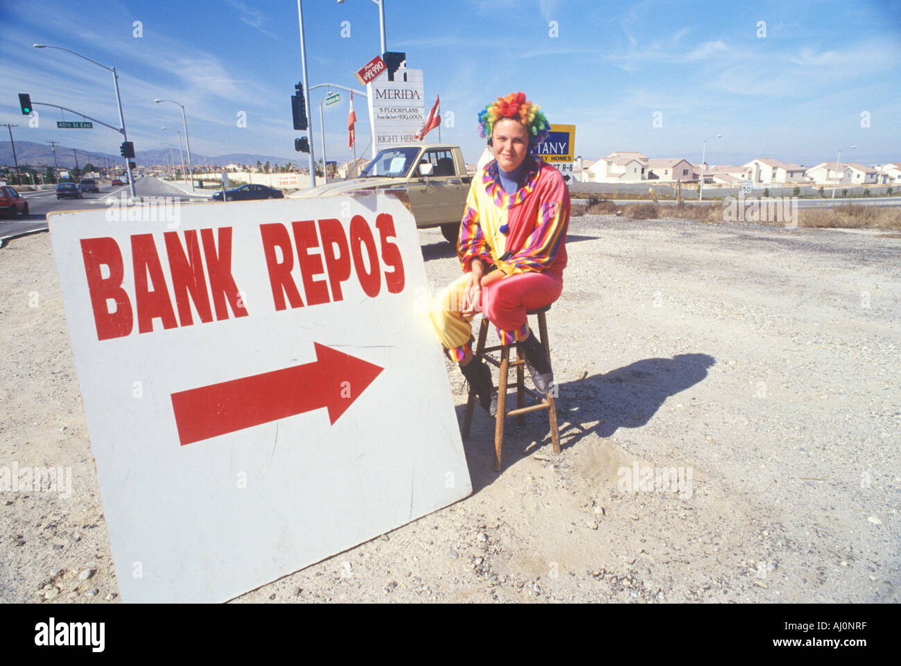 Clown salesperson with Bank Repo sign at roadside dealership Stock ...