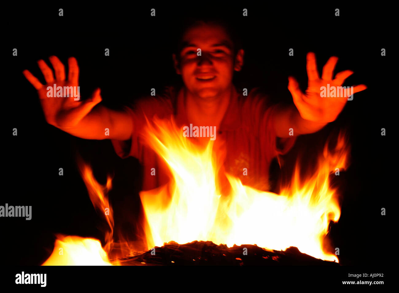Warming hands by fire hi-res stock photography and images - Alamy