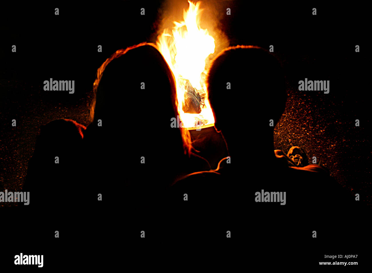 Romantice Setting Man and Woman Gazing into a Raging Campfire on a Cold ...