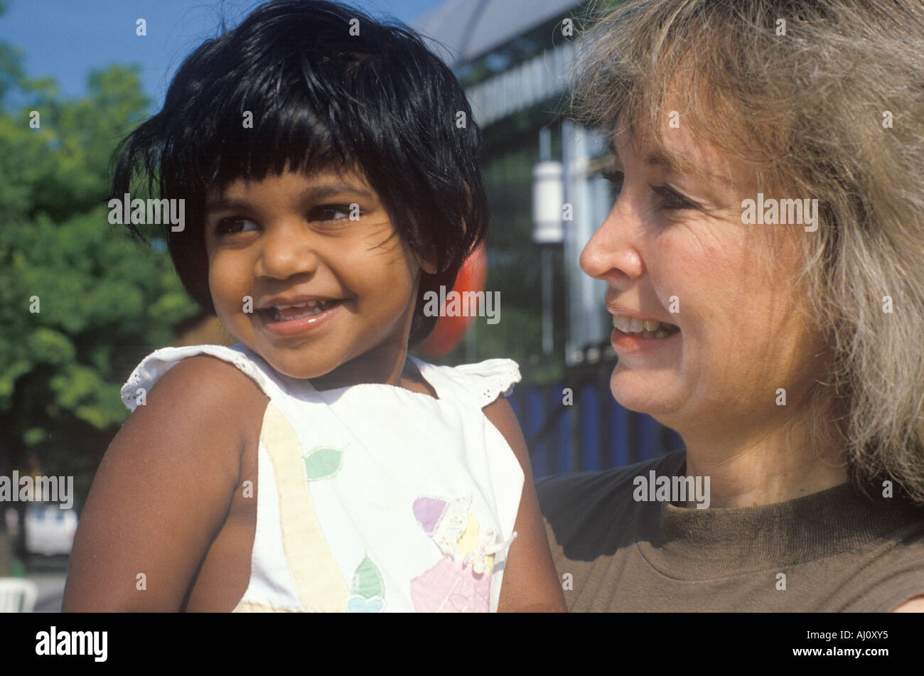 A Caucasian woman holding an Indian child Chevy Chase MD Stock Photo ...