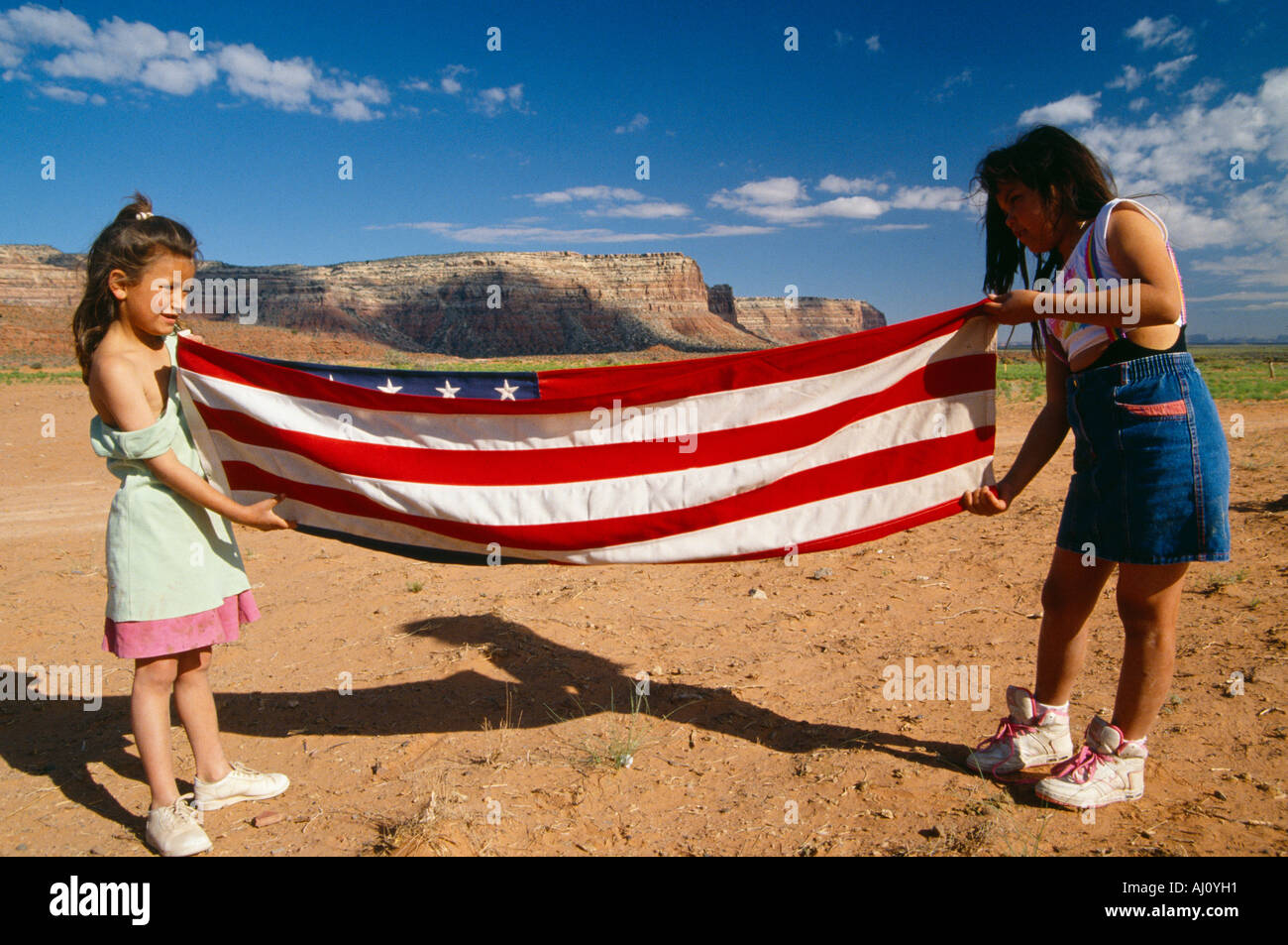 Two girls folding the American flag Lee Ranch UT Stock Photo - Alamy