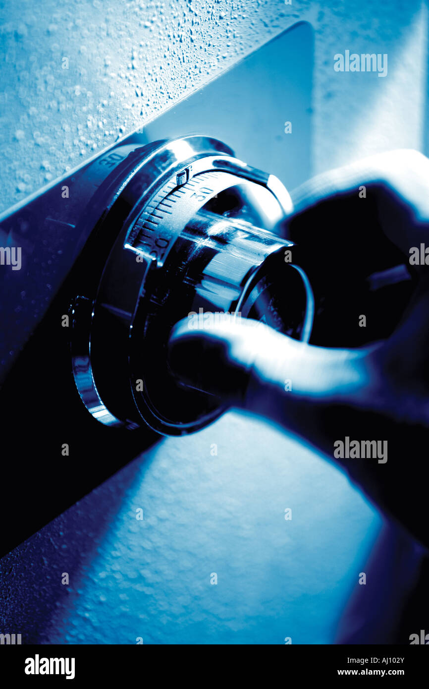 Hand opening a safe, rotating the wheel Stock Photo - Alamy