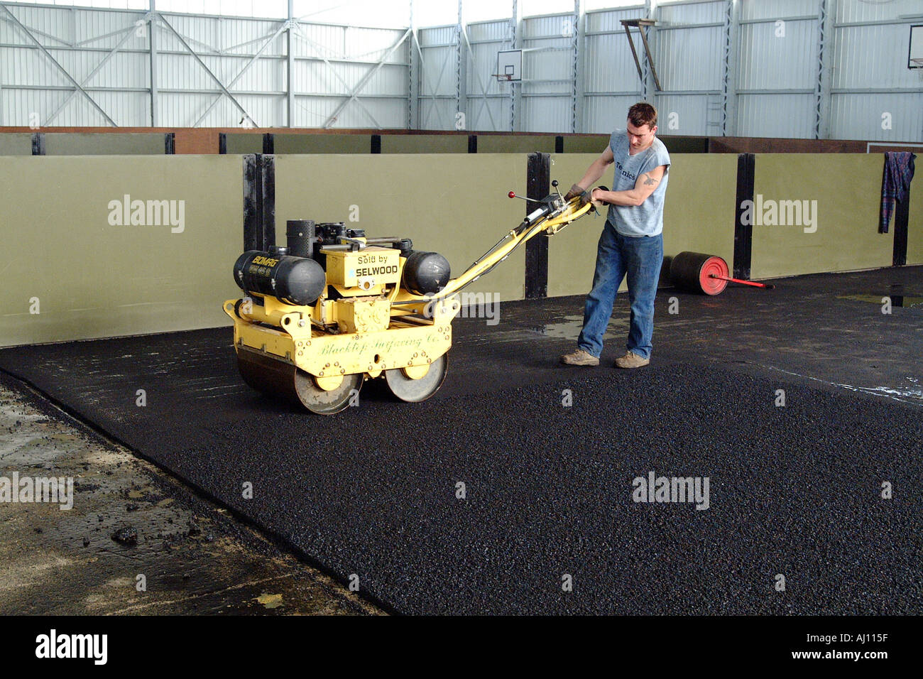 Rolling Tarmac Machine Operative in Sports Arena Stock Photo - Alamy