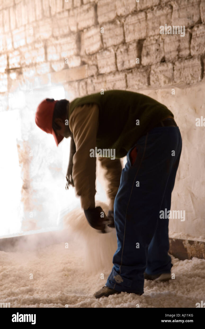 Man drying salt at a small co-operative making table salt at the Salar ...