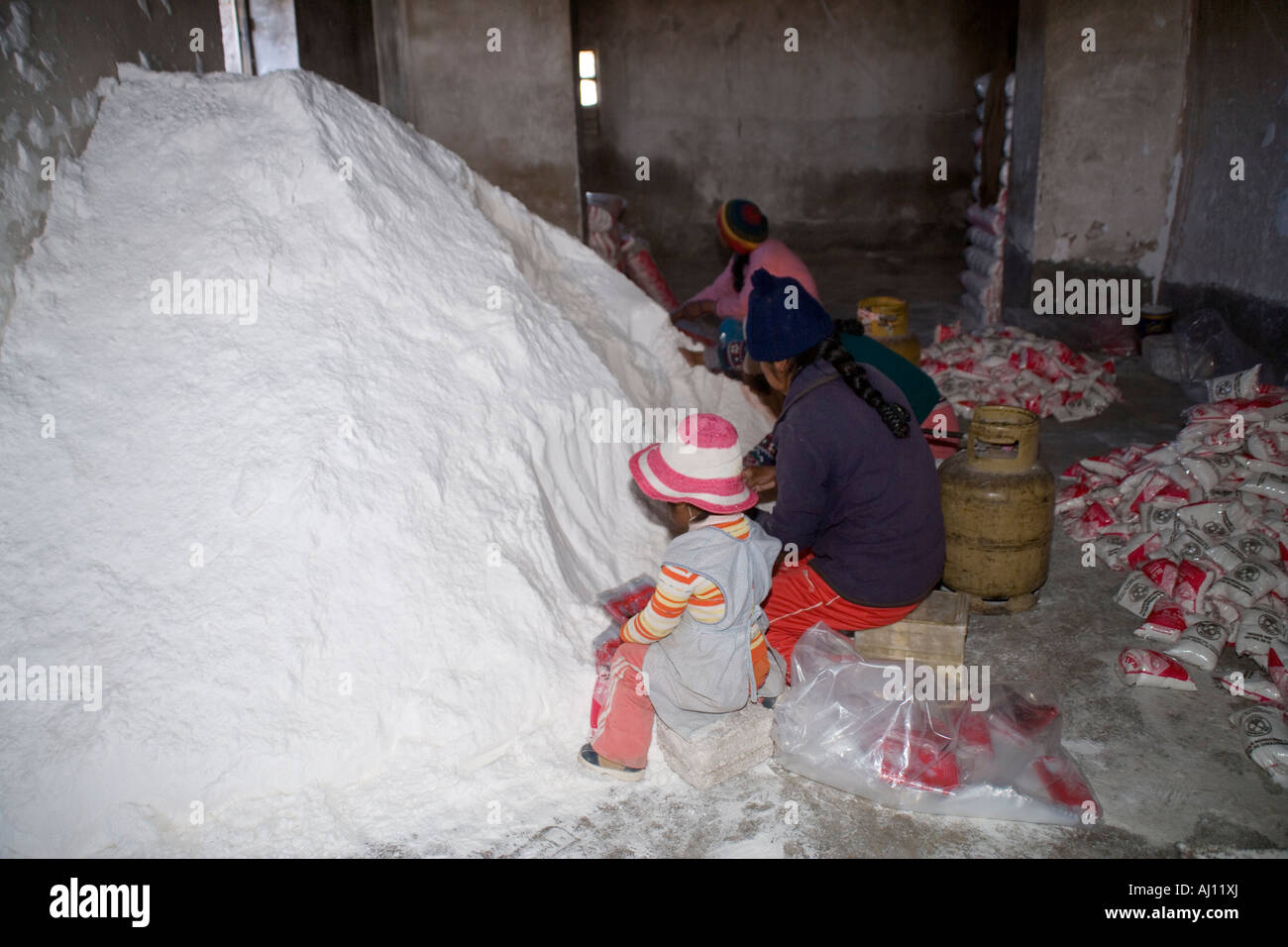 Small girl working at a small co-operative making table salt at the ...