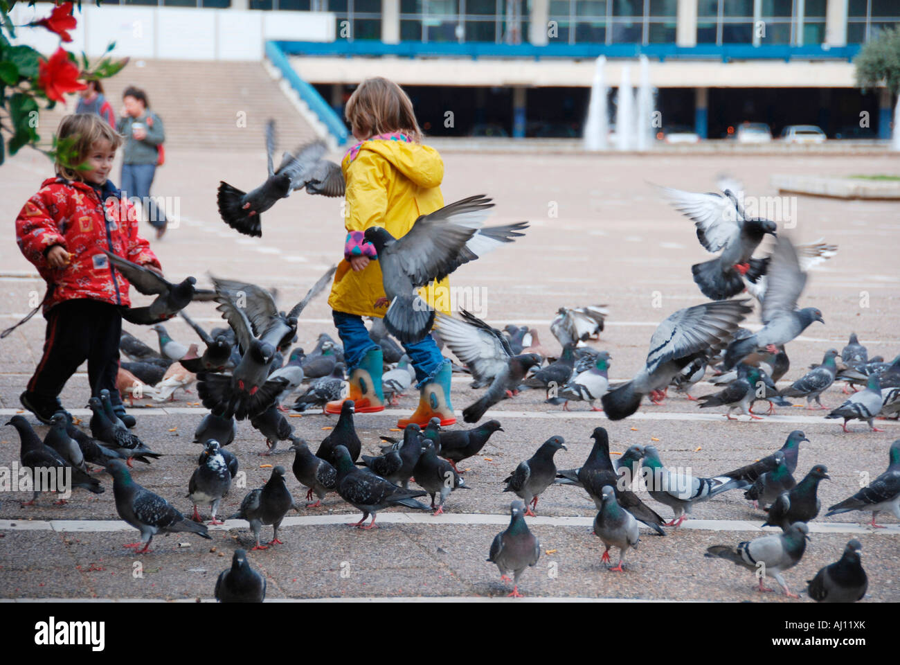 Israel Tel Aviv Kikar Rabin Rabin square children playing with pigeons ...