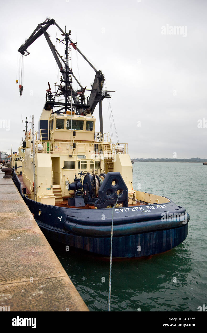 Blue and cream tug boat with large floating crane in background Stock ...