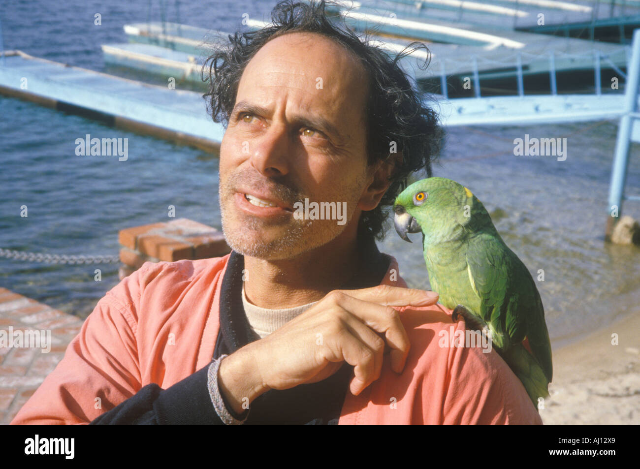 A man with a parrot on his shoulder Stock Photo - Alamy