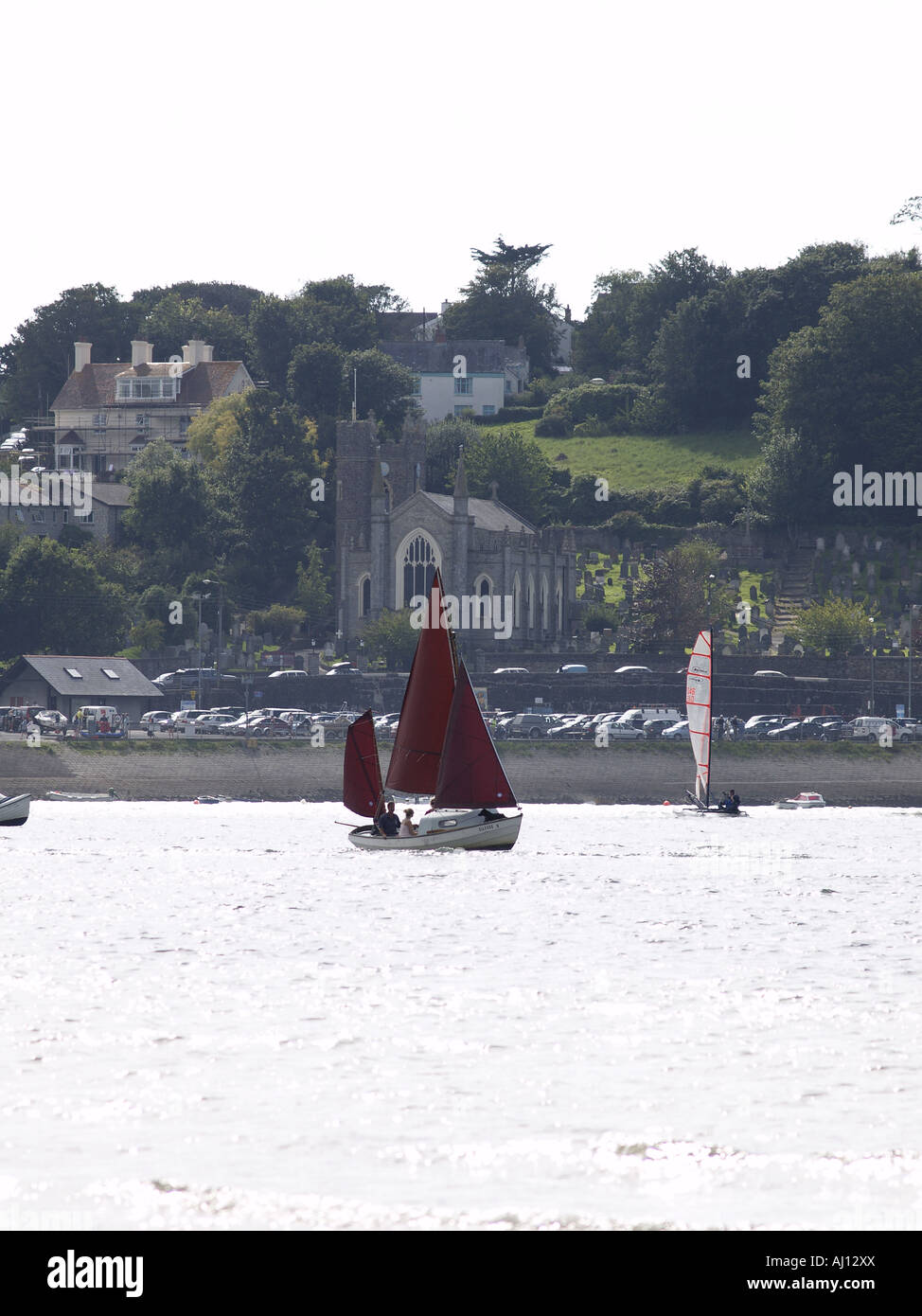 Picturesque view of a Yacht sailing past a beautiful Church Stock Photo ...