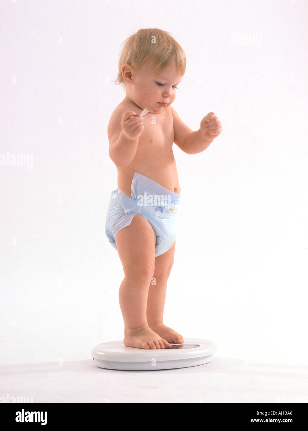 baby boy standing on bathroom scales Stock Photo - Alamy